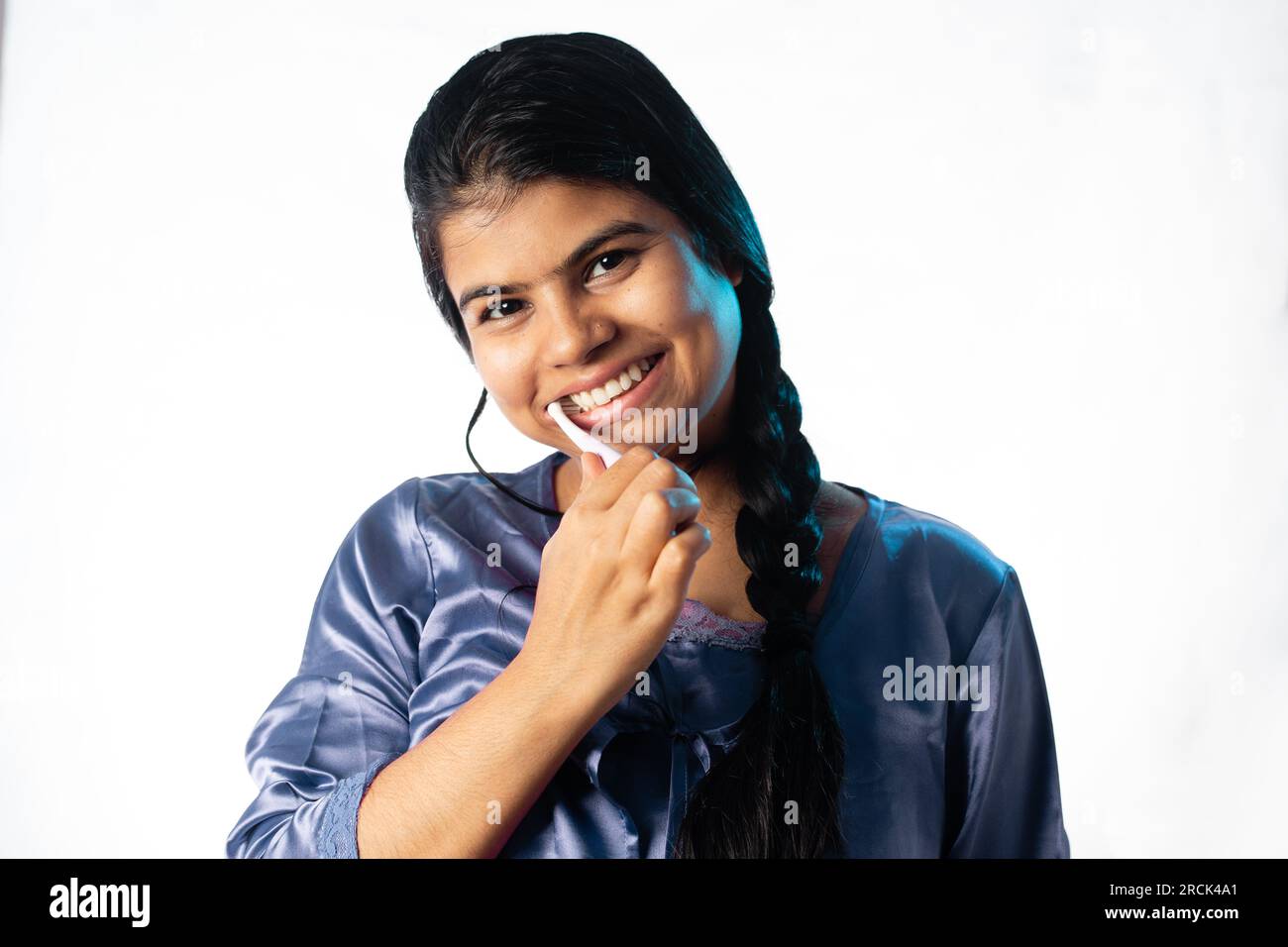 An Indian woman female girl brushing teeth on white background with ...