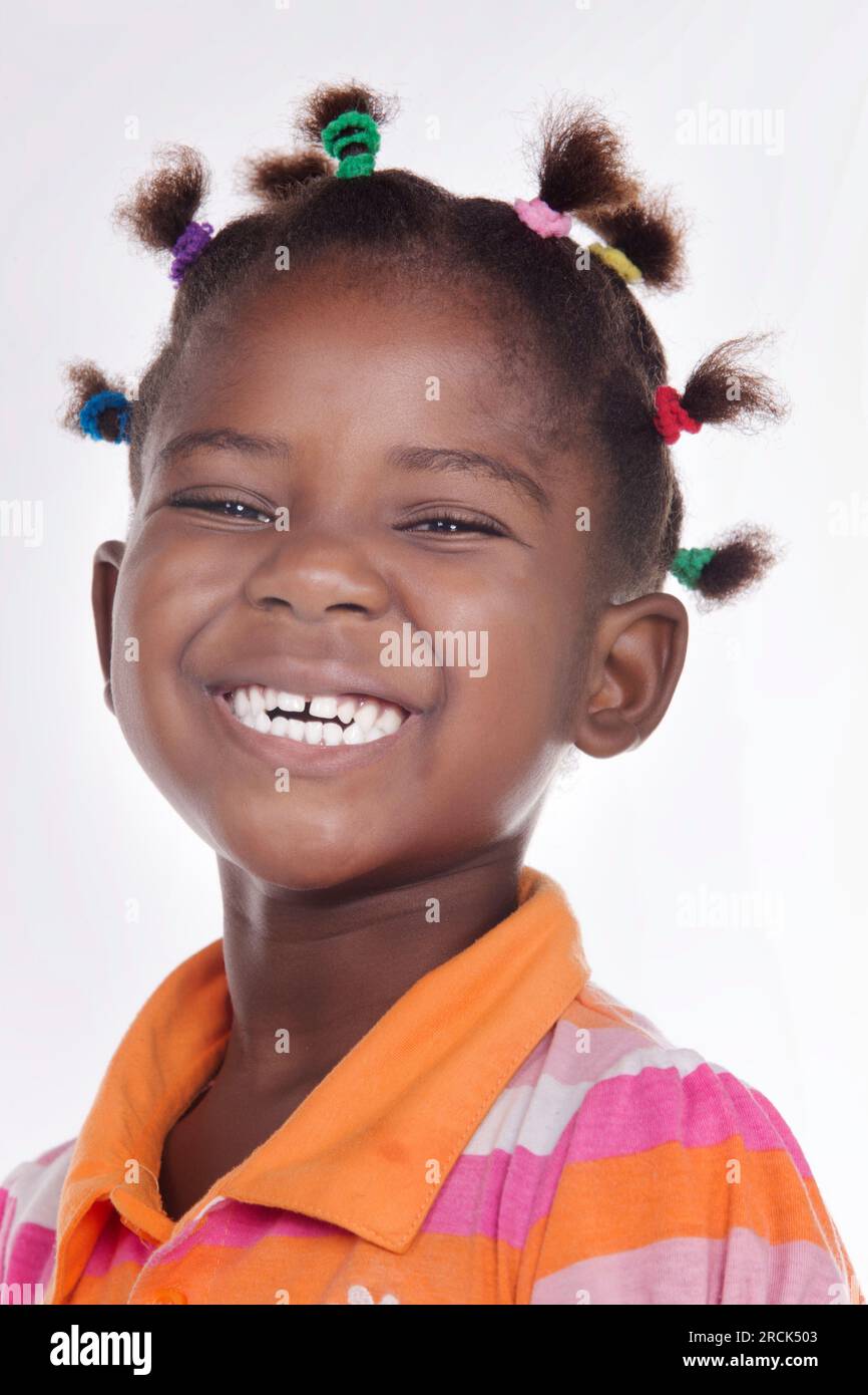 portrait of a happy small african girl with braids studio shot isolated ...