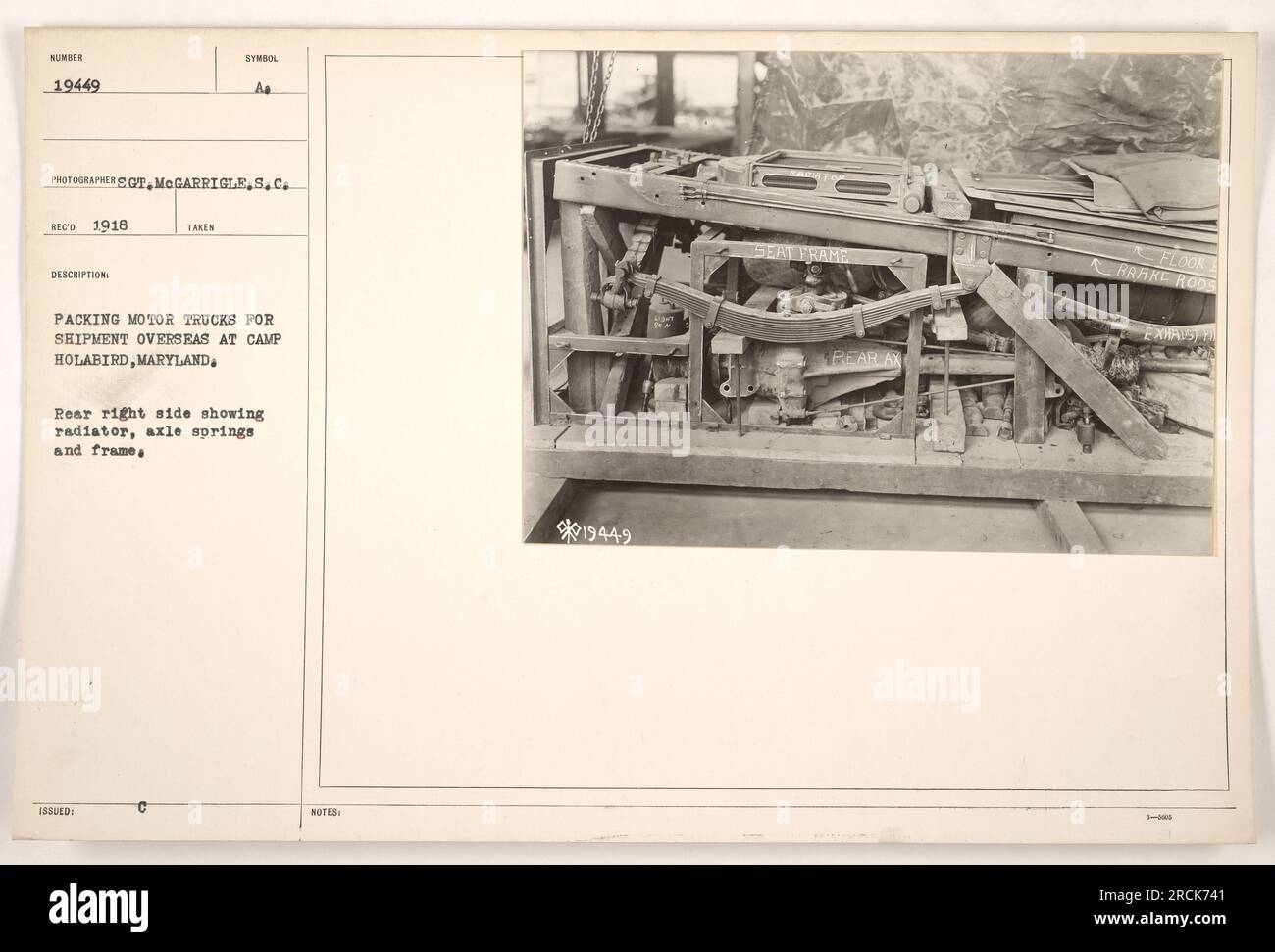 Image shows soldiers packing motor trucks for shipment overseas at Camp ...