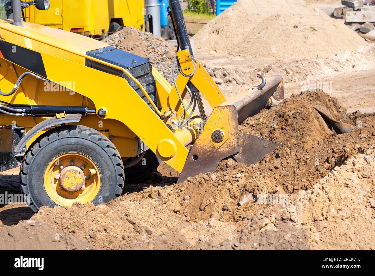 The powerful pneumatic sliding bucket of the wheeled bulldozer works on ...