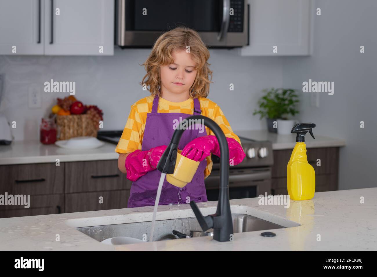 Kid cleaning of kithen help with housework. Cute child boy housekeeping ...