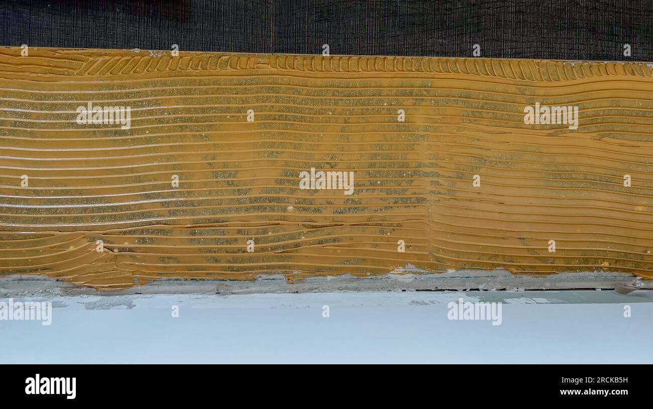 workers apply parquet glue to lay the Listone Giordano Stock Photo - Alamy
