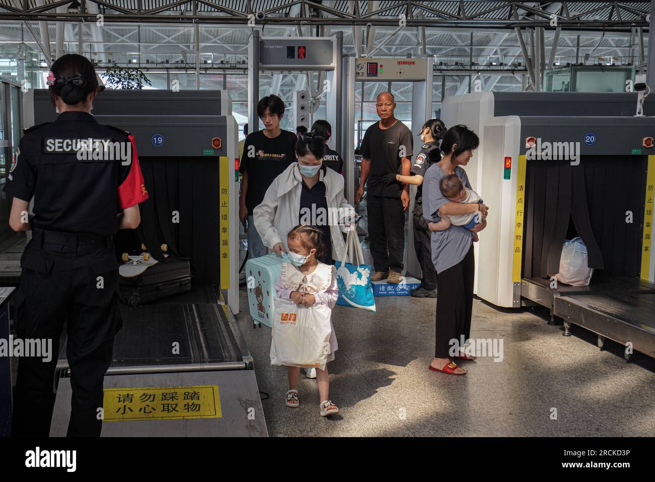 People do security check at the railway station. Guangzhou South ...