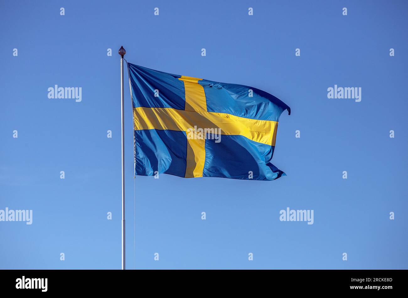 The Swedish flag flying against a bright blue sky. Malmkoping sweden ...