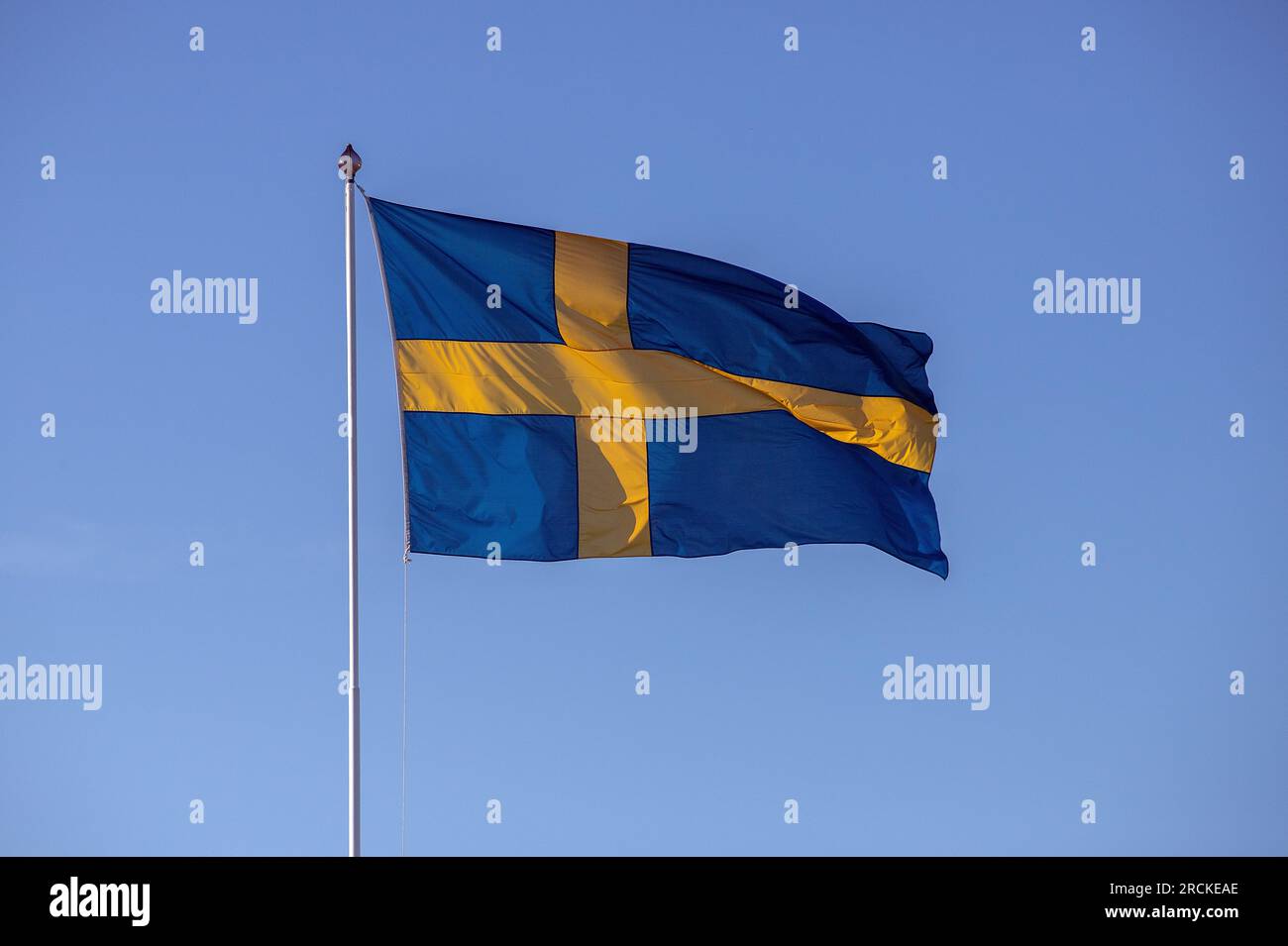 The Swedish flag flying against a bright blue sky. Malmkoping sweden ...