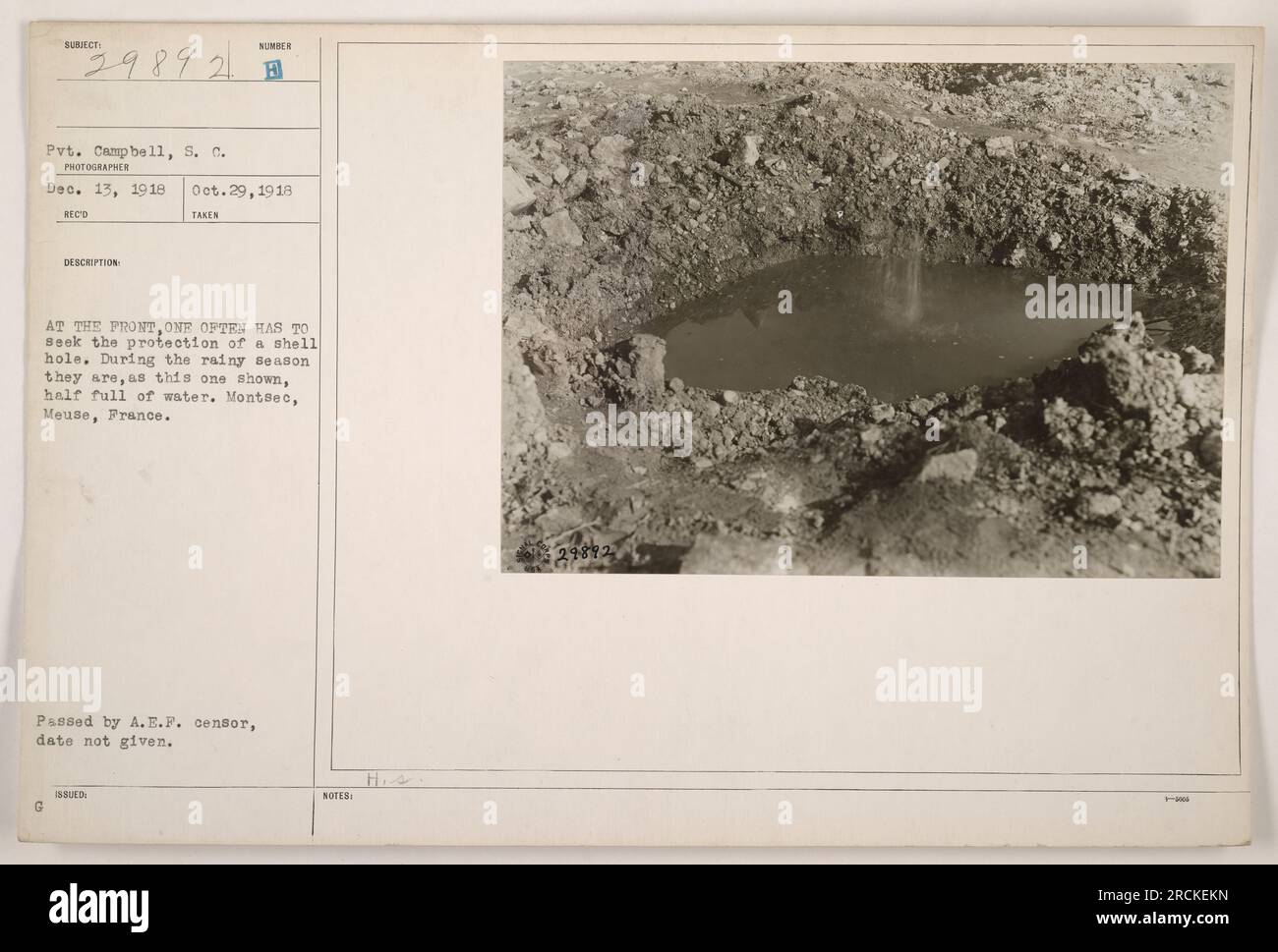 "Pvt. Campbell taking cover in a shell hole during the rainy season at ...