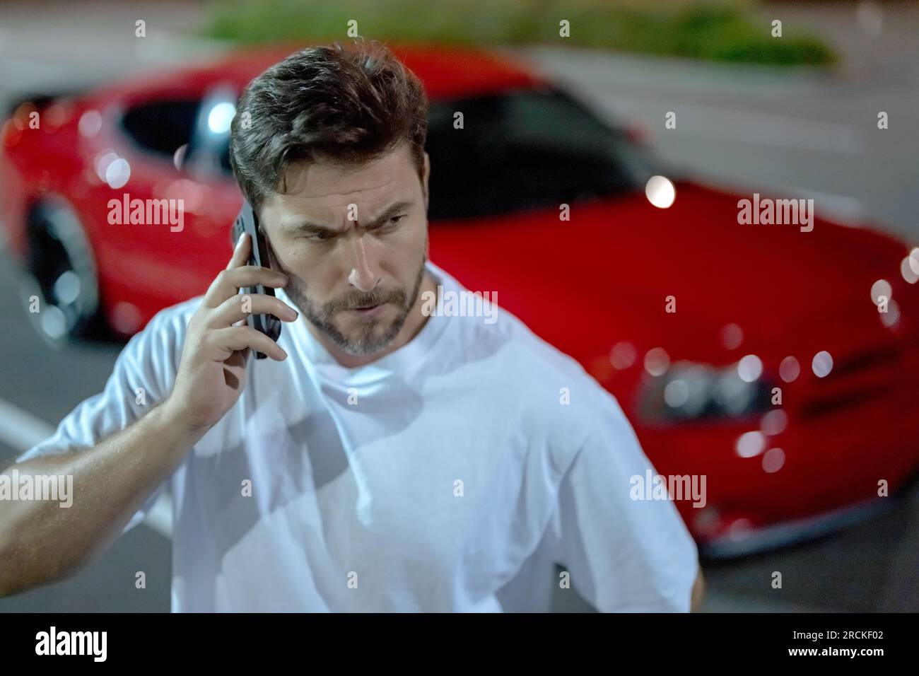 Gangster call phone. Angry man chatting on phone near car on night ...