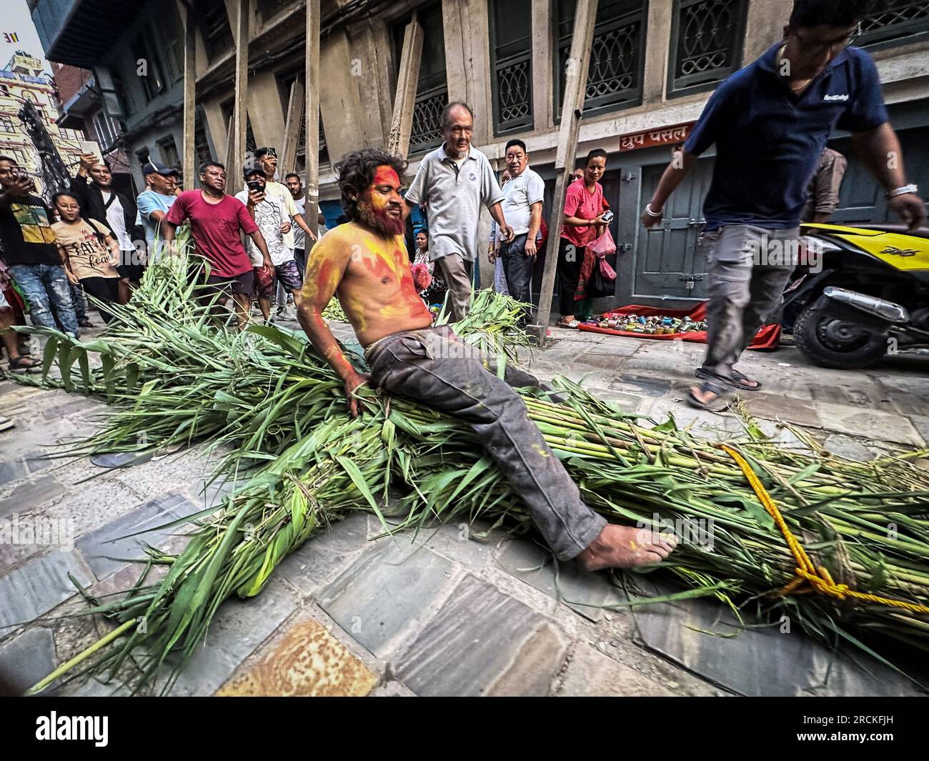 Kathmandu, Bagmati, Nepal. 15th July, 2023. People pull the effigy of a demon along with a man ...