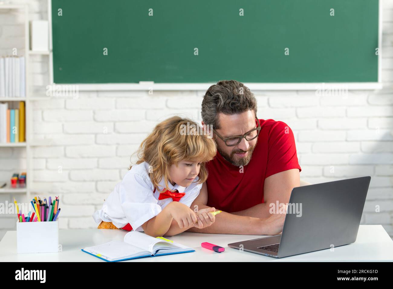 Kid boy learning with teacher. Funny little boy study with father in ...