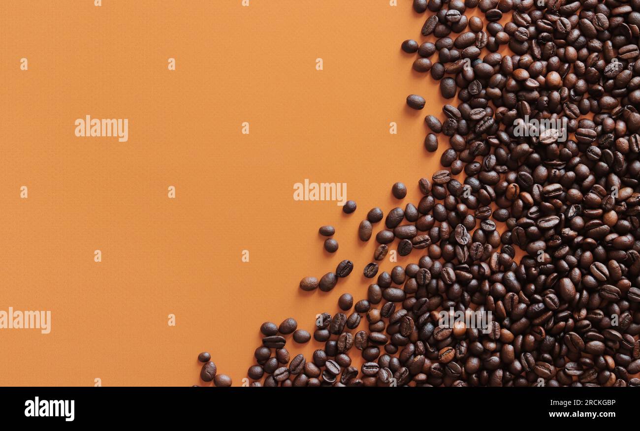 Roasted coffee beans on orange background, top view. Pile of halves of ...
