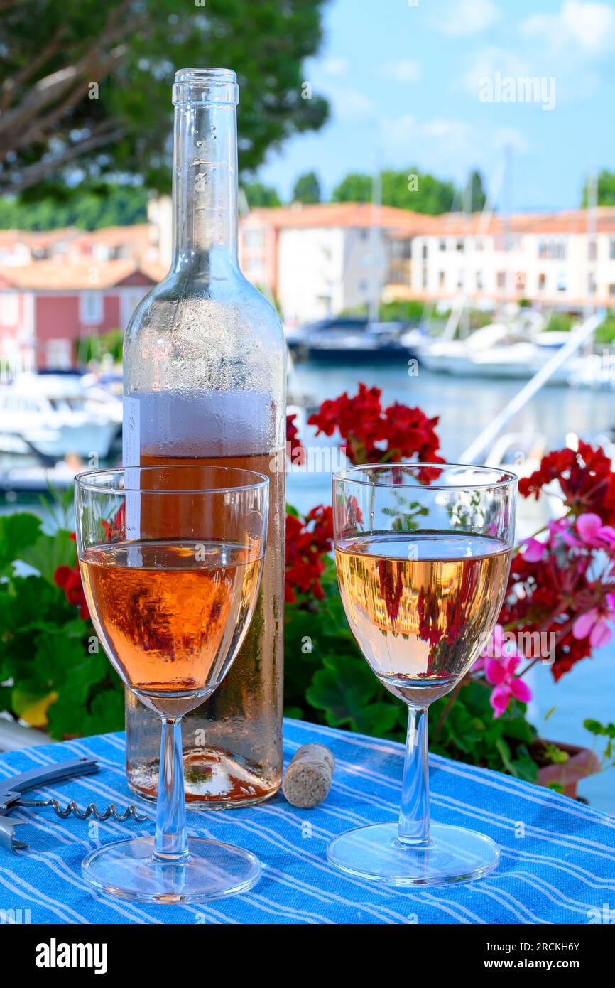 Glasses of cold rose Cote de Provence wine in yacht harbour of Port ...