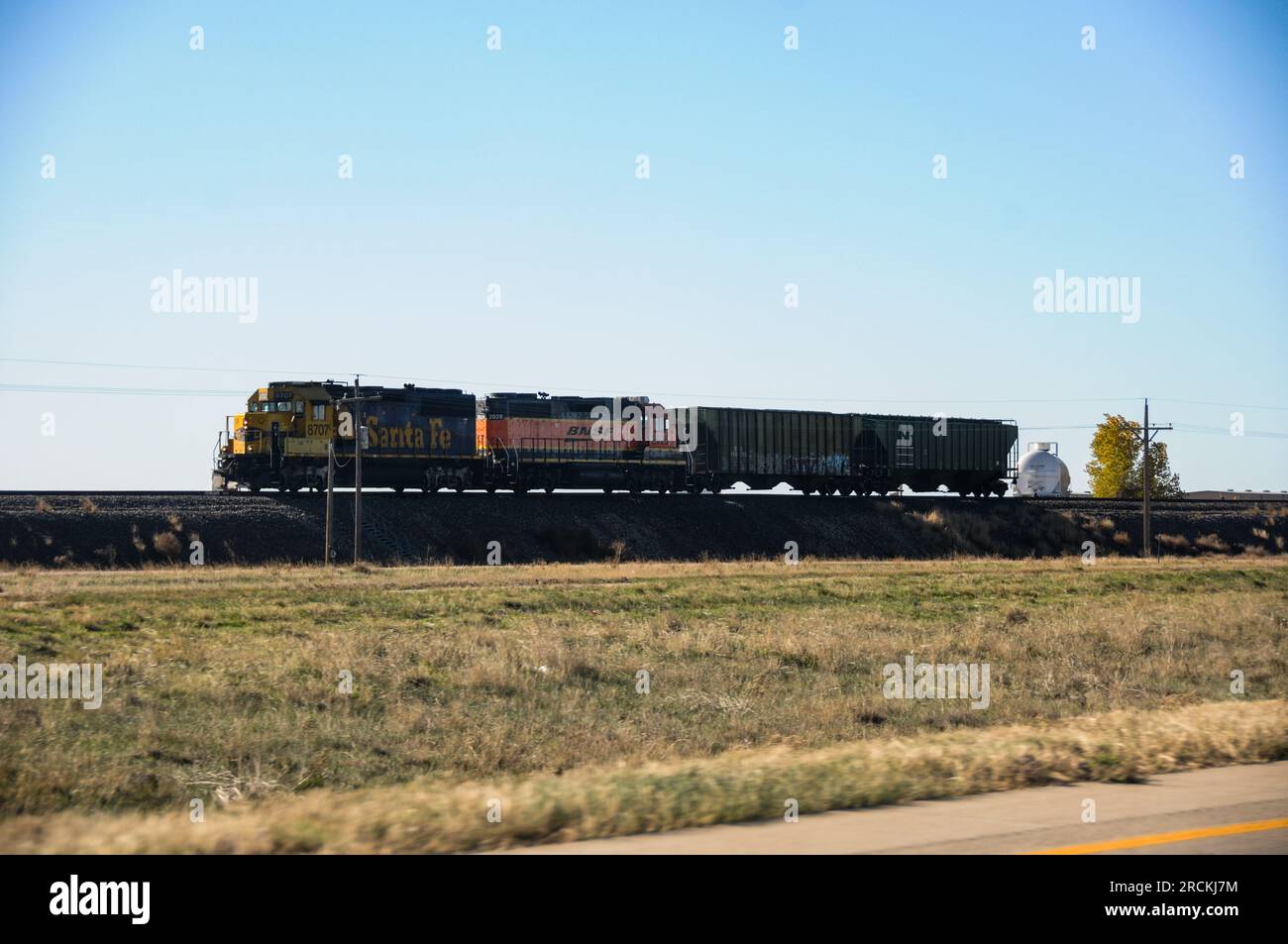 Santa Fe diesel train engine pulling cars along track in Colorado, USA ...