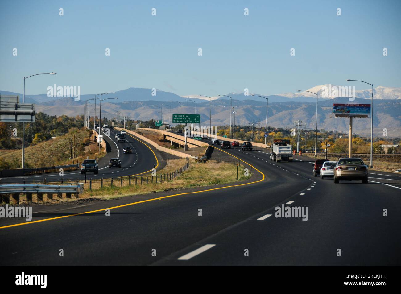 Vehicles on Interstate 76 leading into Denver, Colorado, USA with rocky ...