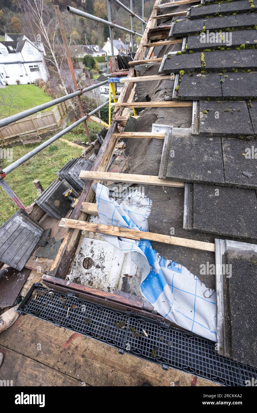 Edge of roof requiring repair with rotted woodwork and felt, Wales, UK ...