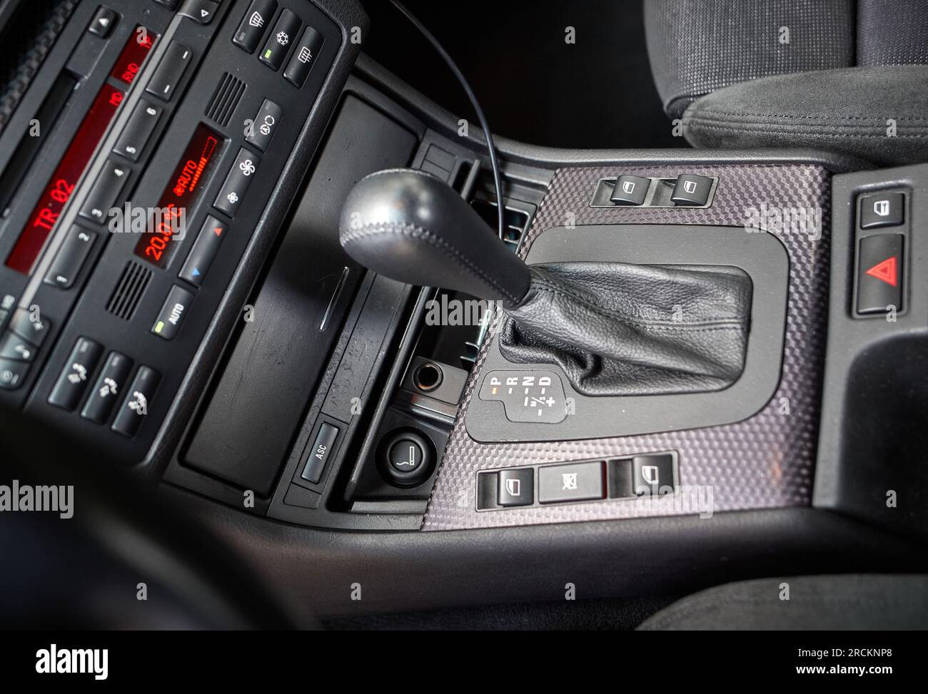 Shift lever, car steering wheel and sensors. Inside a modern car view ...