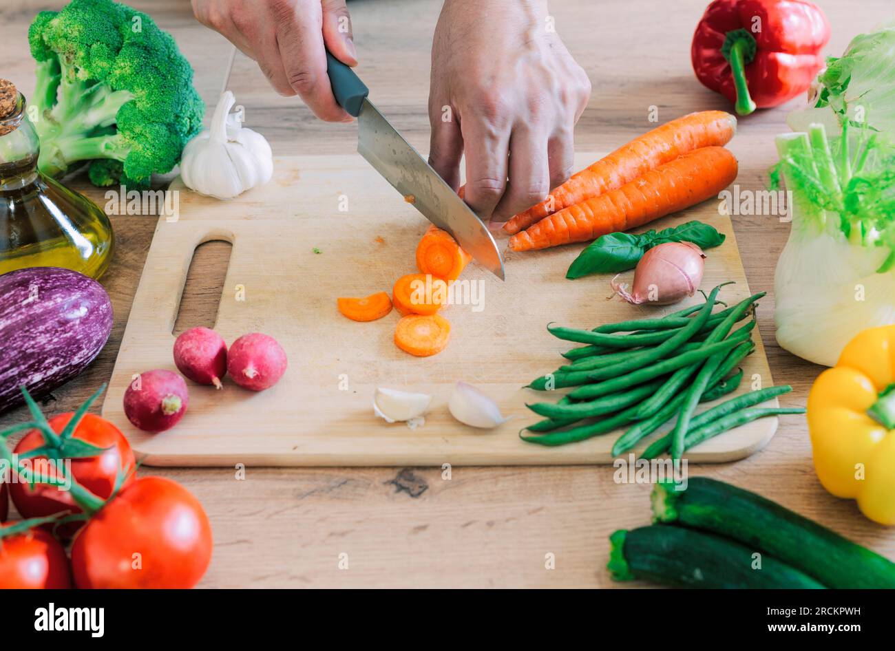 Hands cutting vegetables in the kitchen Stock Photo - Alamy