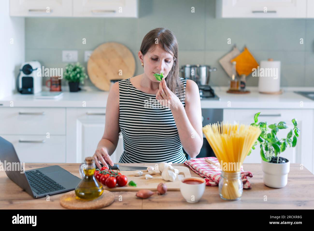 Beautiful woman cooking and having fun at the kitchen. Girl cooking ...