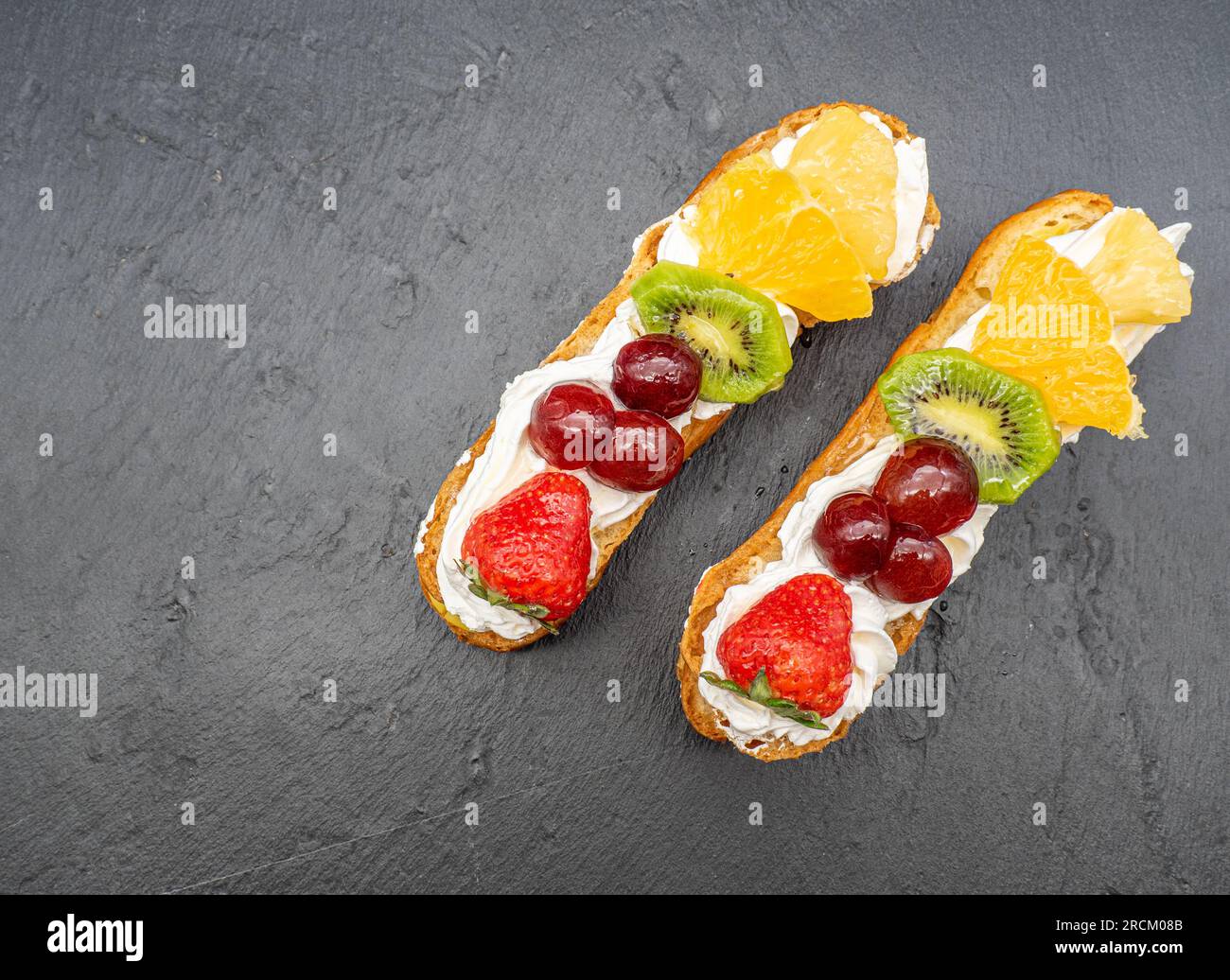homemade french eclairs with cream and assorted season fruits Stock ...