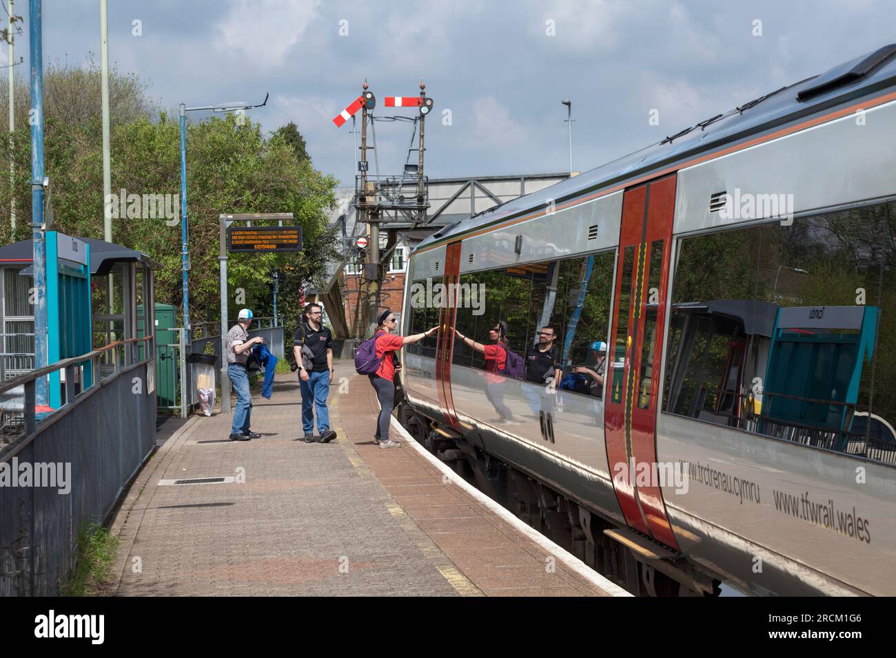 Passengers boarding a Transport For Wales train at Tondu railway ...