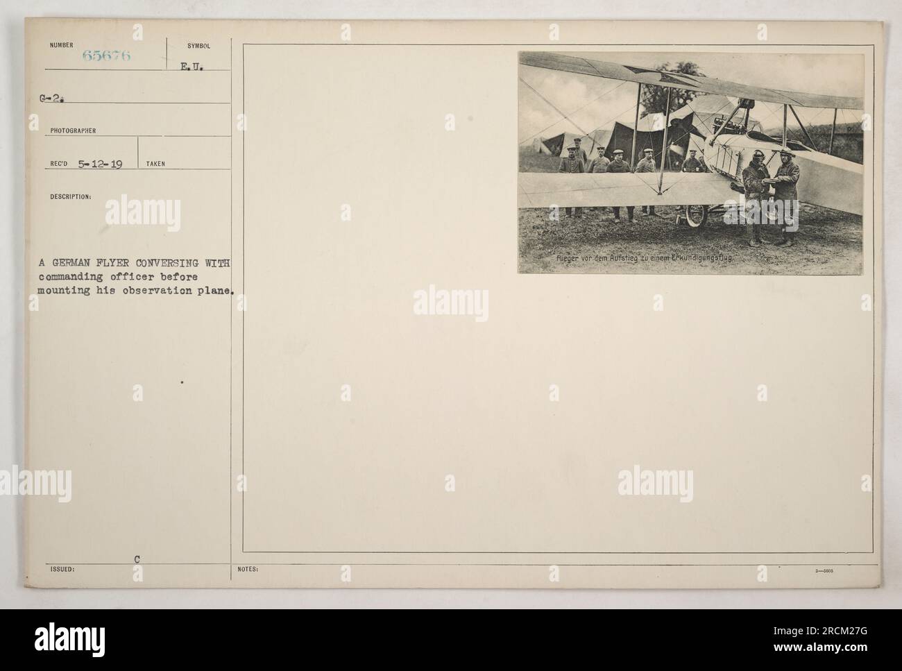 A German flyer discussing with his commanding officer before boarding ...