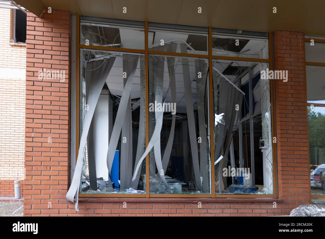 Broken windows of civilian building of bomb explosion. Shards of glass ...