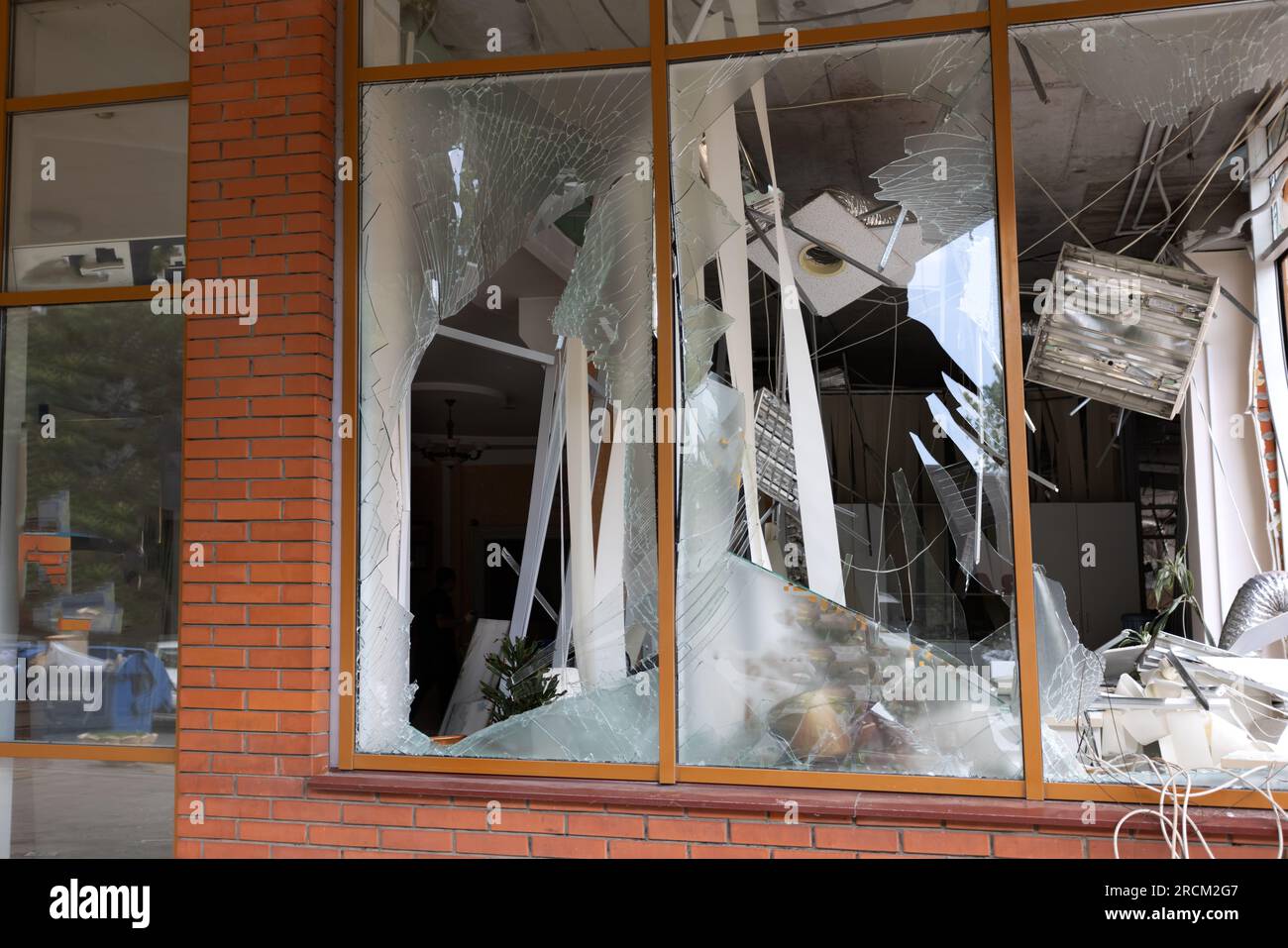 Broken windows of civilian building of bomb explosion. Shards of glass ...