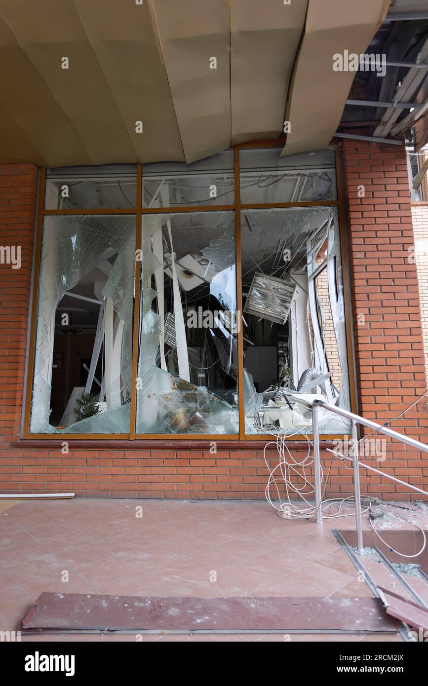 Broken windows of civilian building of bomb explosion. Shards of glass ...