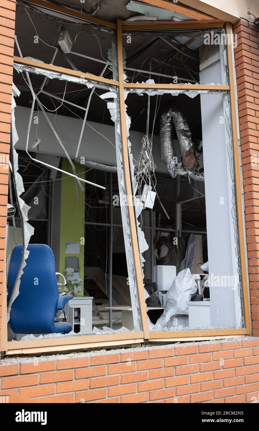 Broken windows of civilian building of bomb explosion. Shards of glass ...