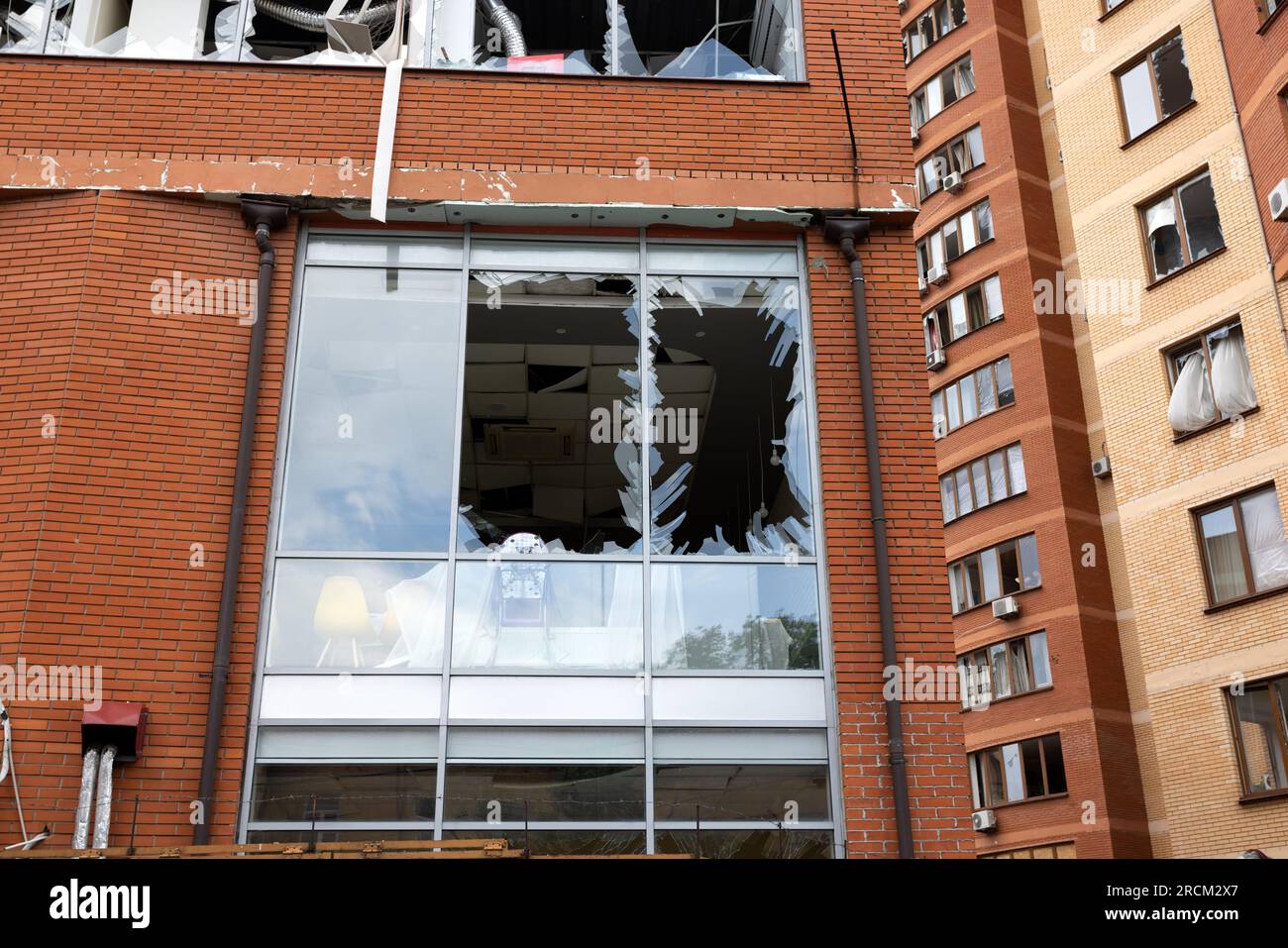 Broken windows of civilian building of bomb explosion. Shards of glass ...