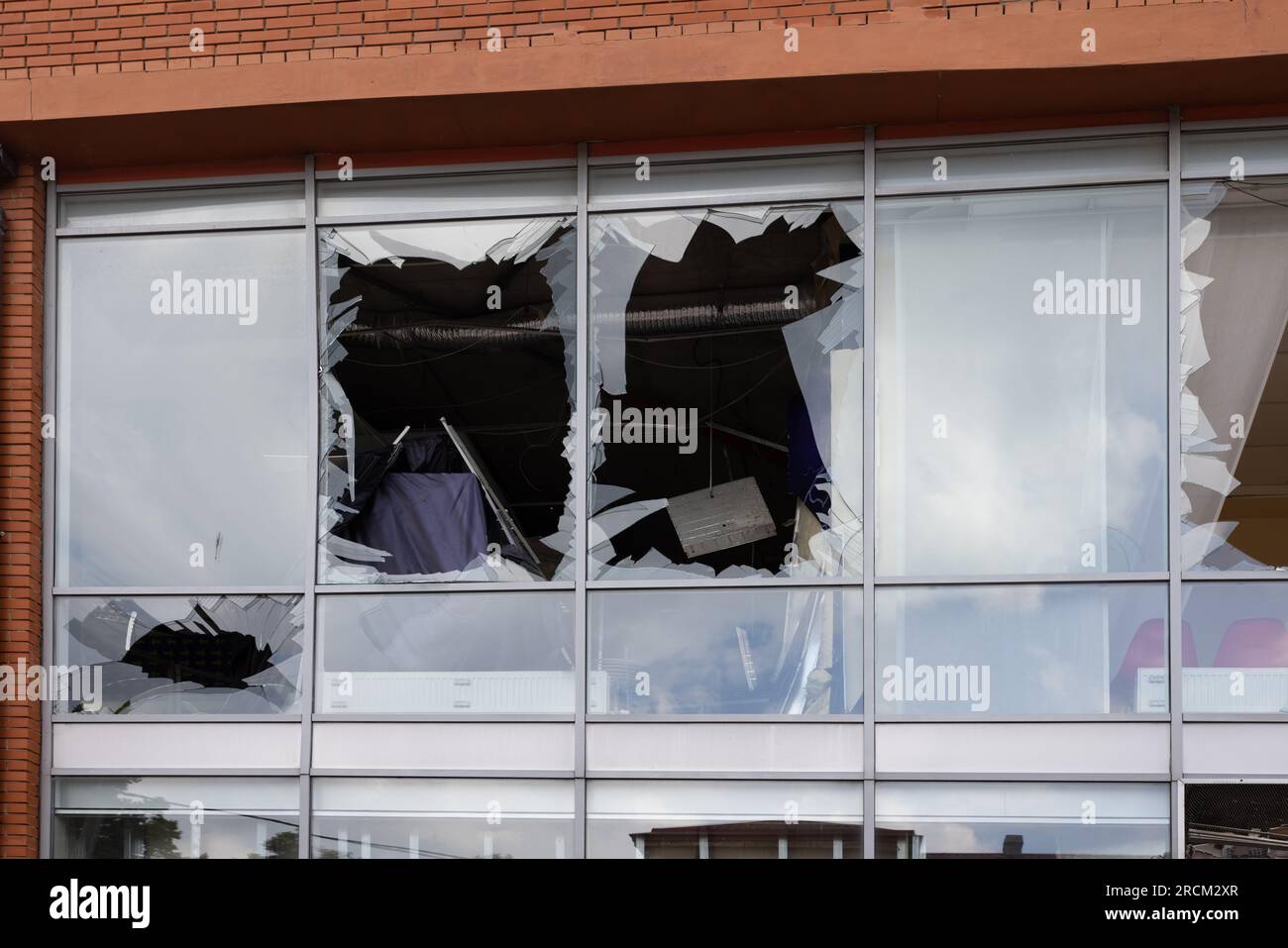 Broken windows of civilian building of bomb explosion. Shards of glass ...