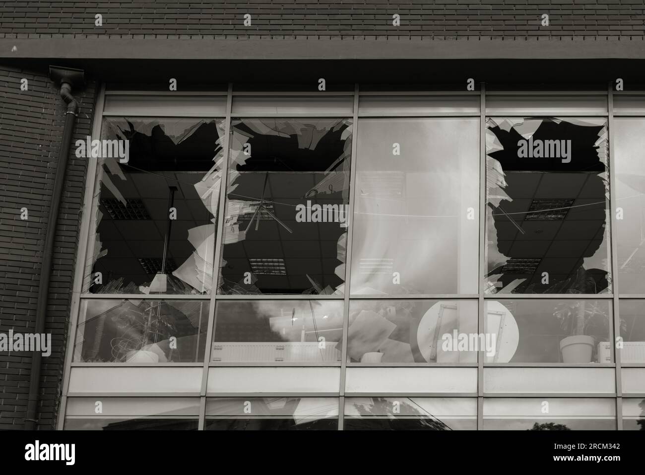 Broken windows of civilian building of bomb explosion. Shards of glass ...
