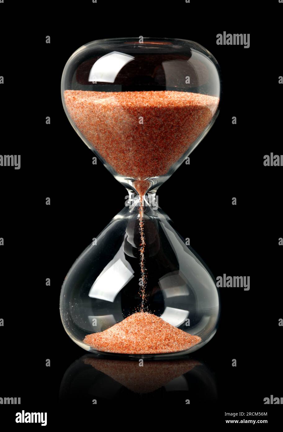 Hourglass with red sand showing the passage of time Stock Photo - Alamy