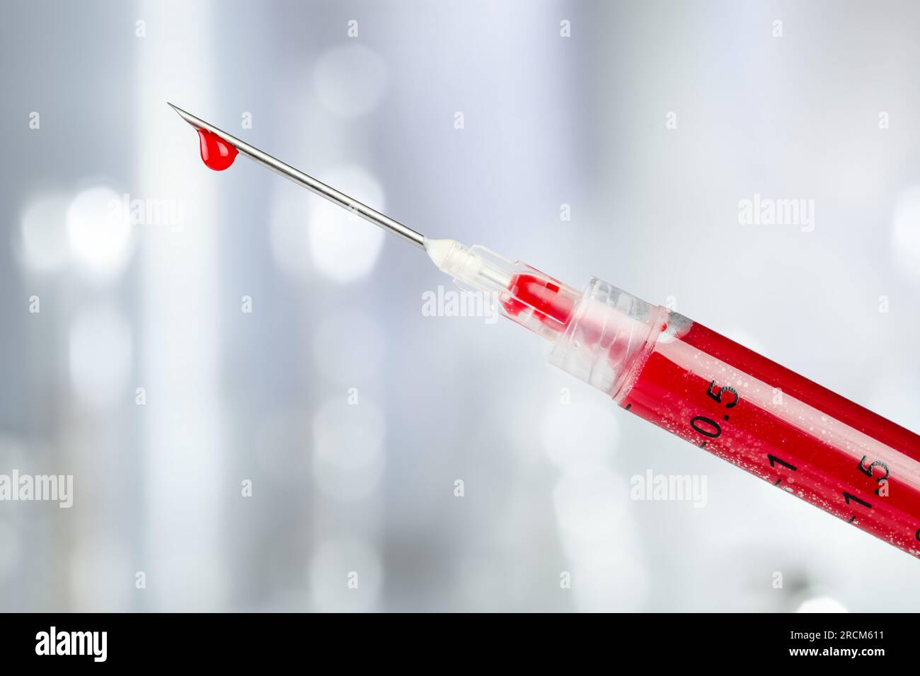 Syringe filled with blood and dripping from the needle Stock Photo - Alamy