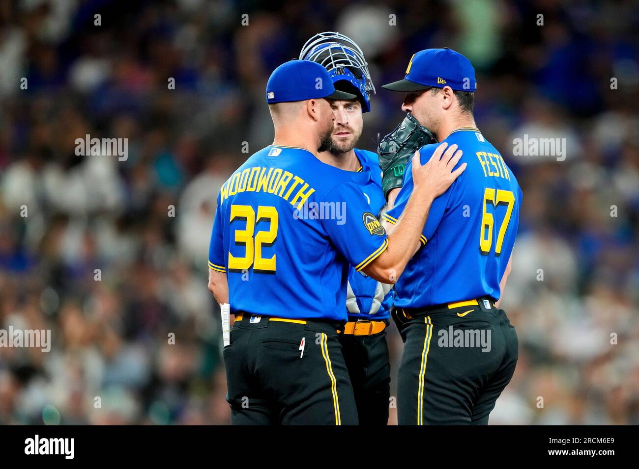 Seattle Mariners pitching coach Pete Woodworth (32) talks with catcher ...