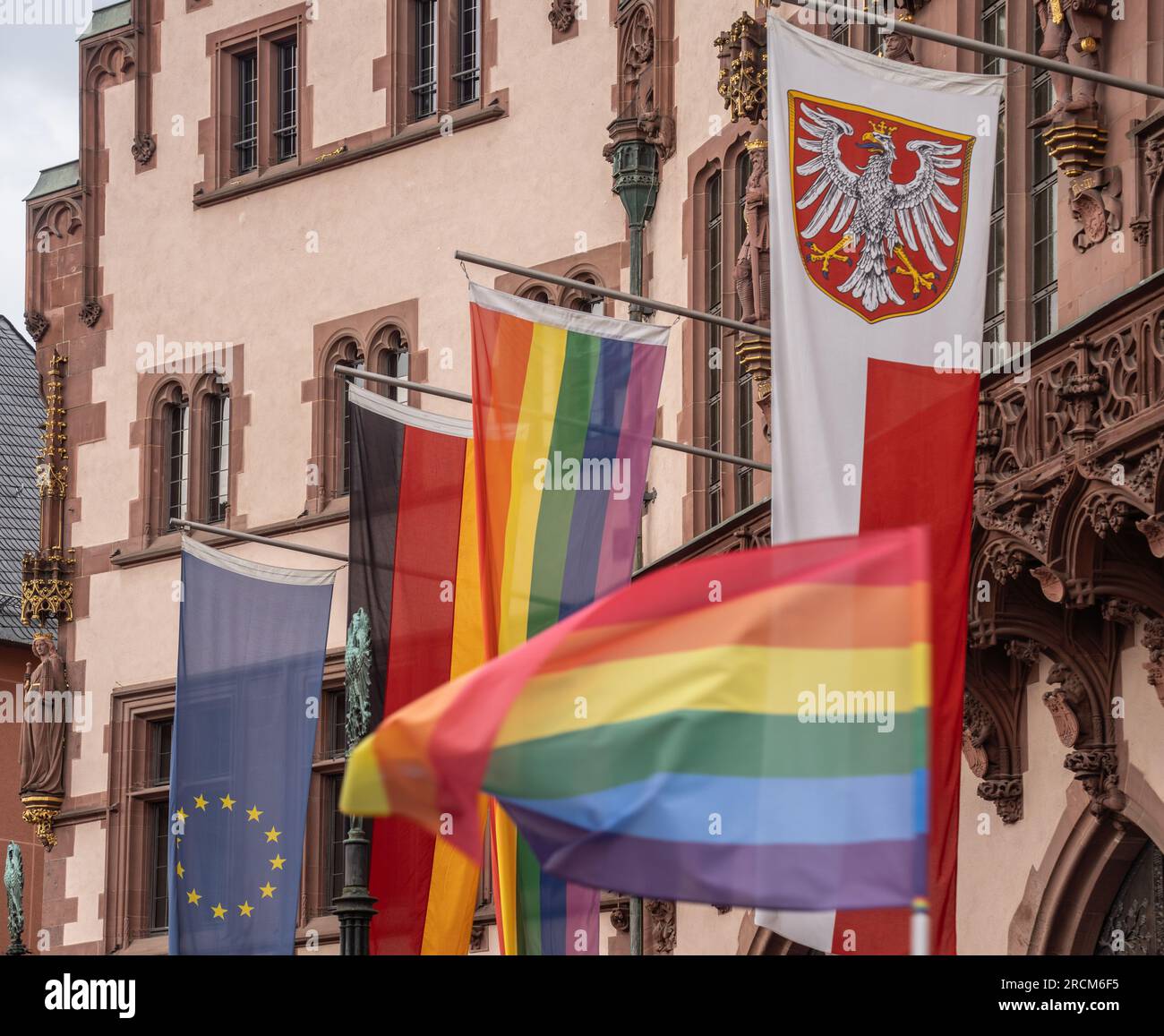 15 July 2023, Hesse, Frankfurt/Main: Rainbow flags (bottom and center ...