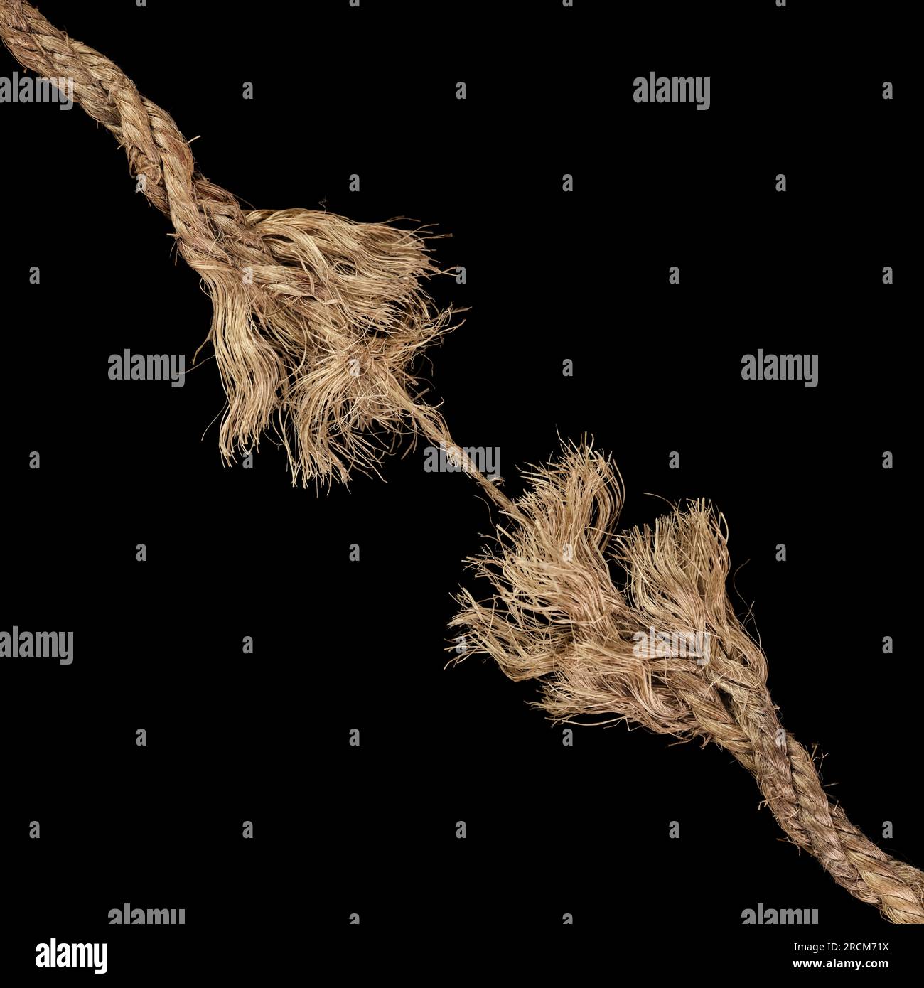 Dirty rope, frayed at both ends and ready to break apart with rope held ...