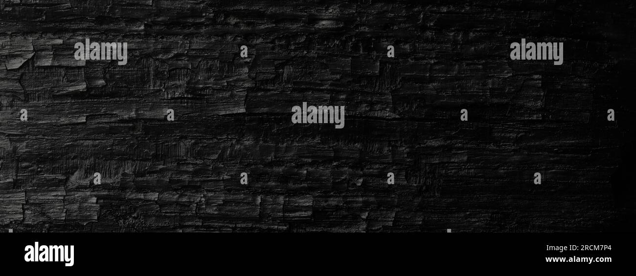 Dark black background of rough burnt wood, soot, and ash. Burn texture ...