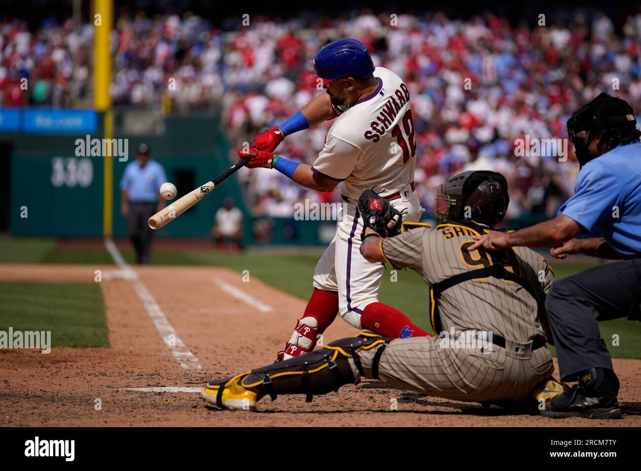 Philadelphia Phillies' Kyle Schwarber, left, hits a run-scoring single ...