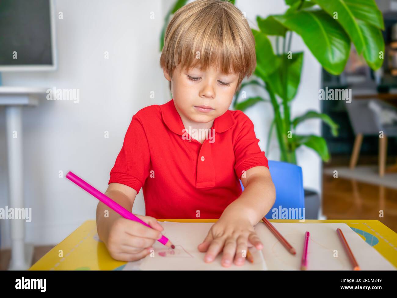 Back to school. Portrait of little child boy writing, drawing in ...