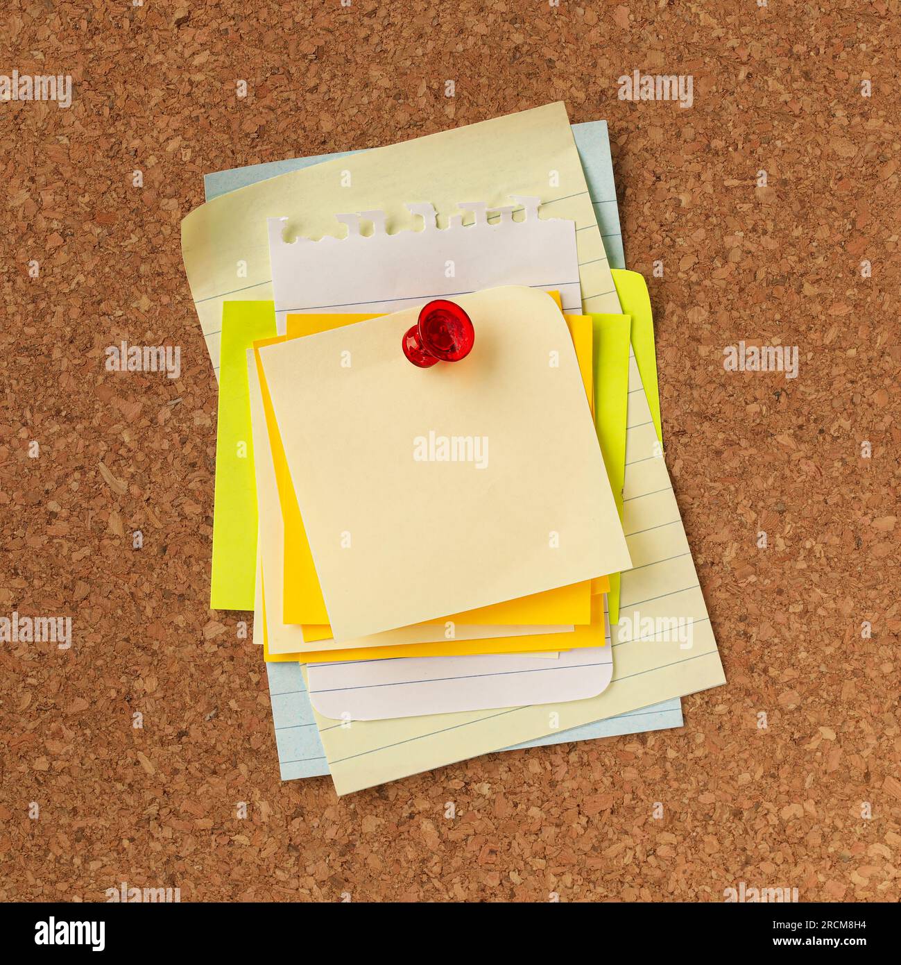 Pile of blank yellow notes stacked and pinned with a red tack. Empty ...