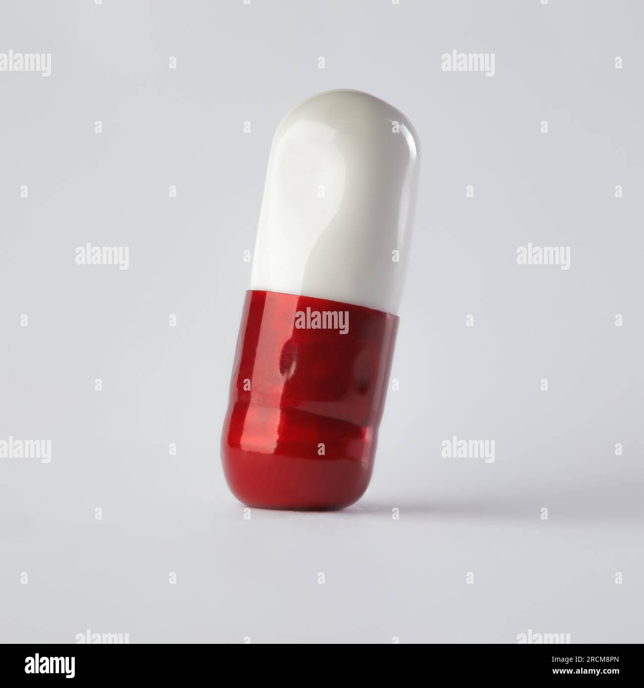 Close up of a single pill capsule in red and white. Concept for single ...