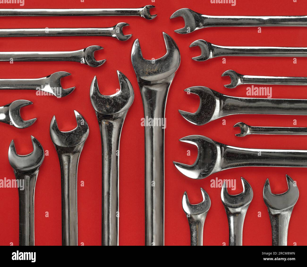 Set of worn and used wrenches lined up on red background Stock Photo ...