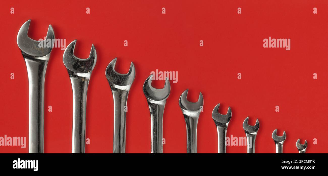 Set of worn and used wrenches lined up on red background Stock Photo ...