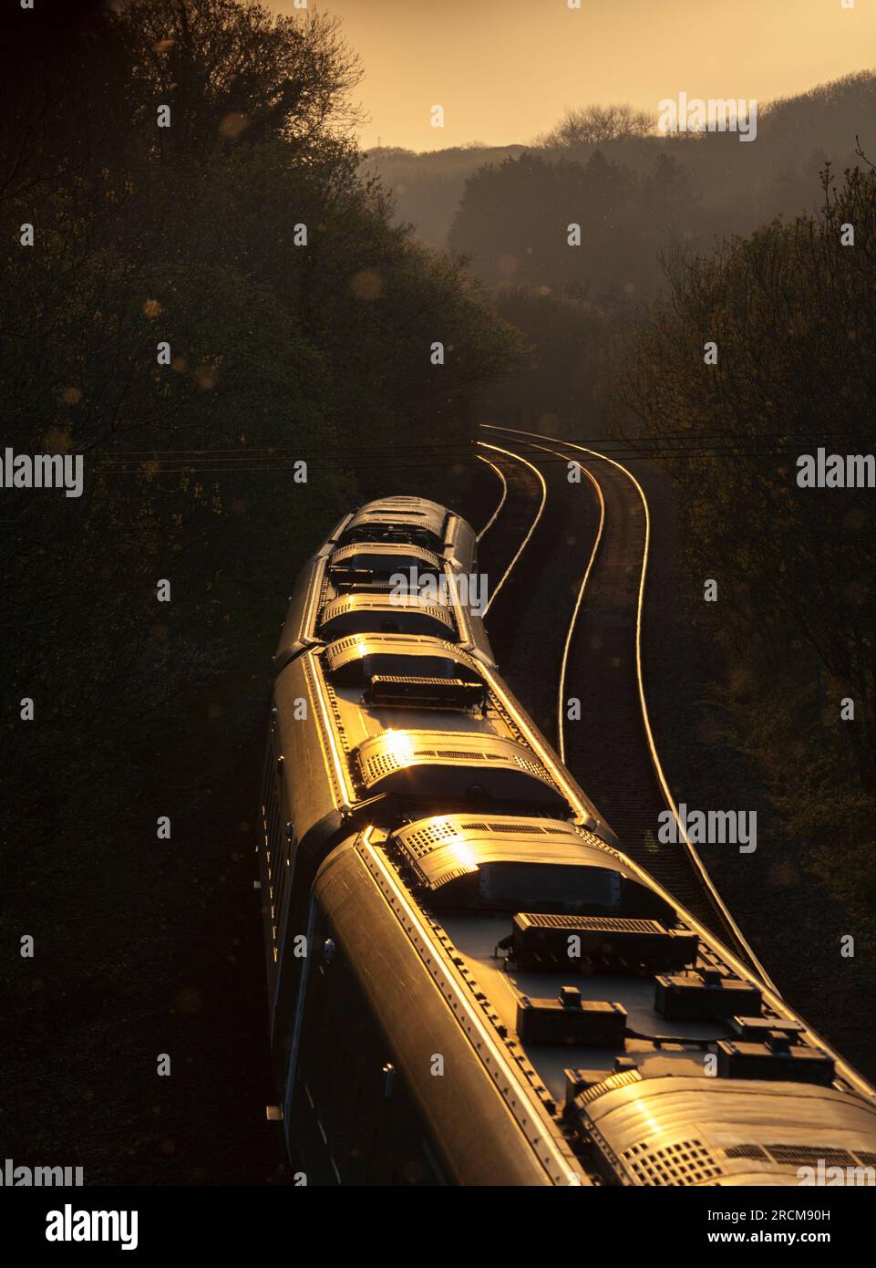 First Great Western railway Hitachi IET bi - mode train heading into the sunset on the south ...