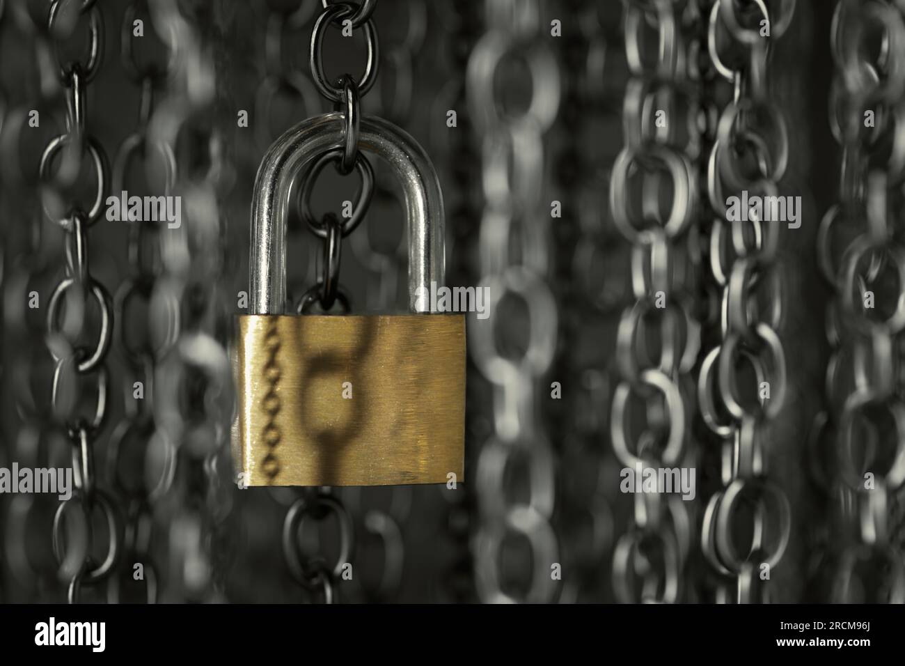 Metal chains hanging vertically with a shiny lock. Business data ...