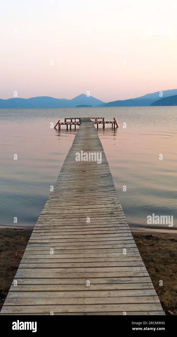 A view of Lake Prespa in North Macedonia from the beach and wooden pier ...