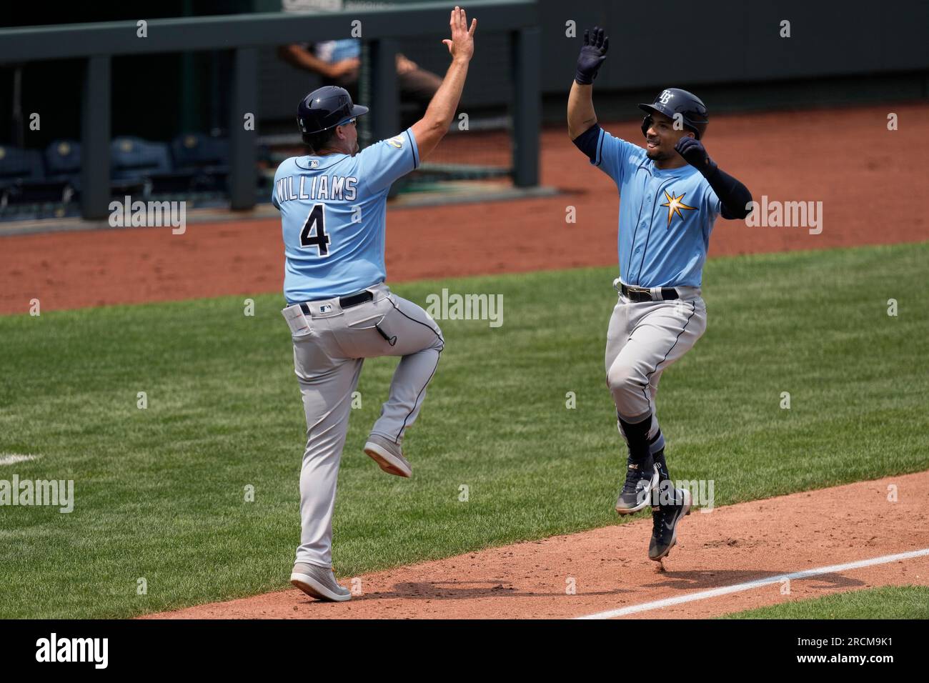 Tampa Bay Rays' Francisco Mejia celebrates with third base coach Brady ...