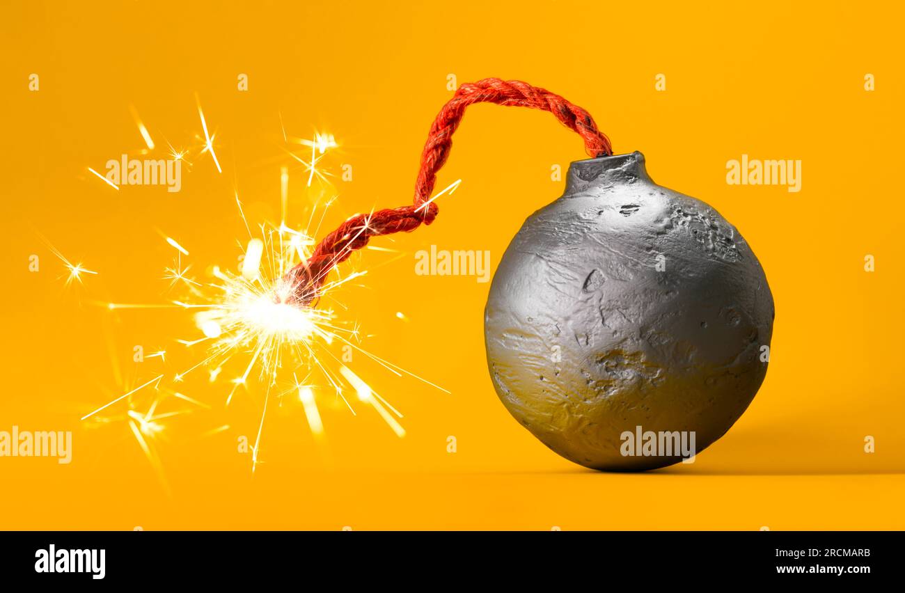 Round black bomb with lit fuse burning with sparks. Bomb about to ...