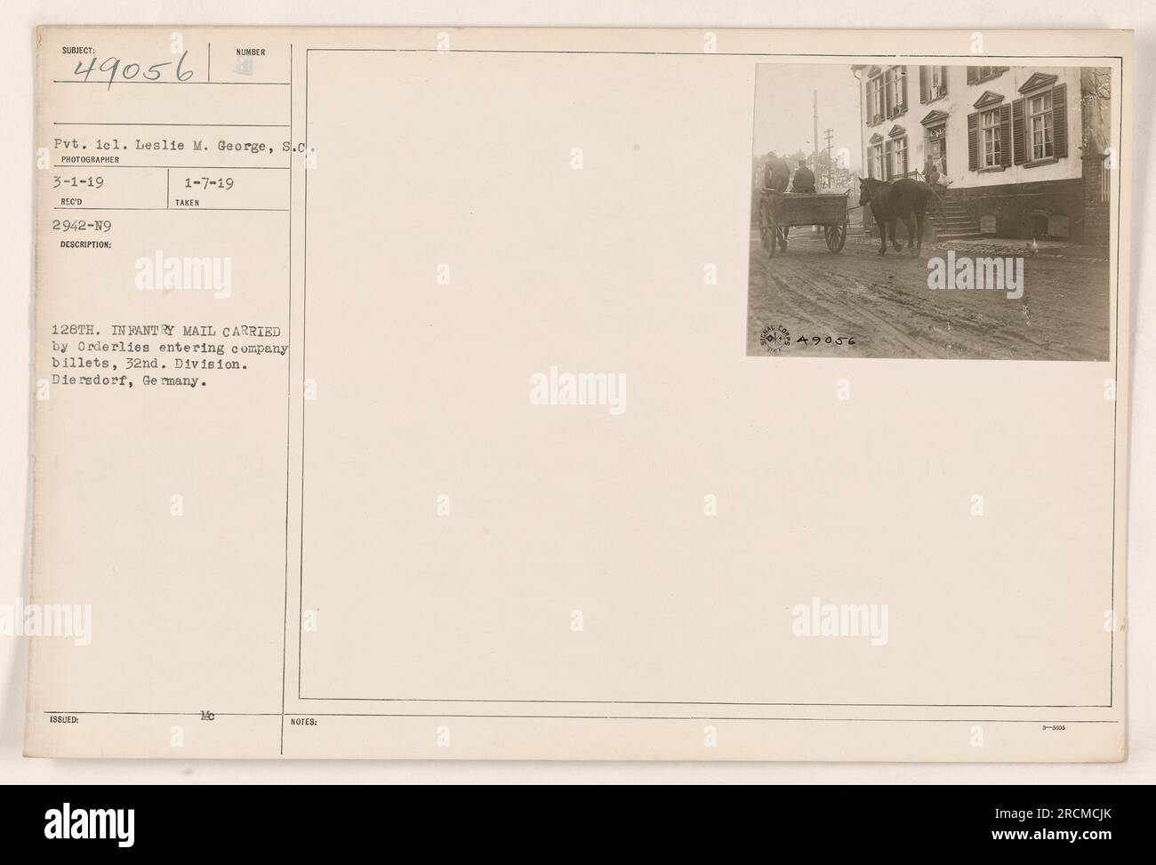 Orderlies from the 128th Infantry carrying mail into company billets in ...