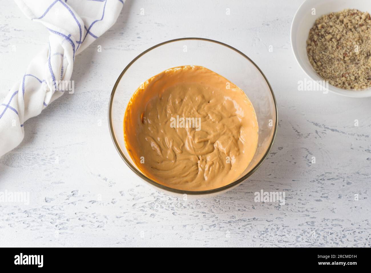 Glass bowl with cream of boiled condensed milk and cream cheese, and ...